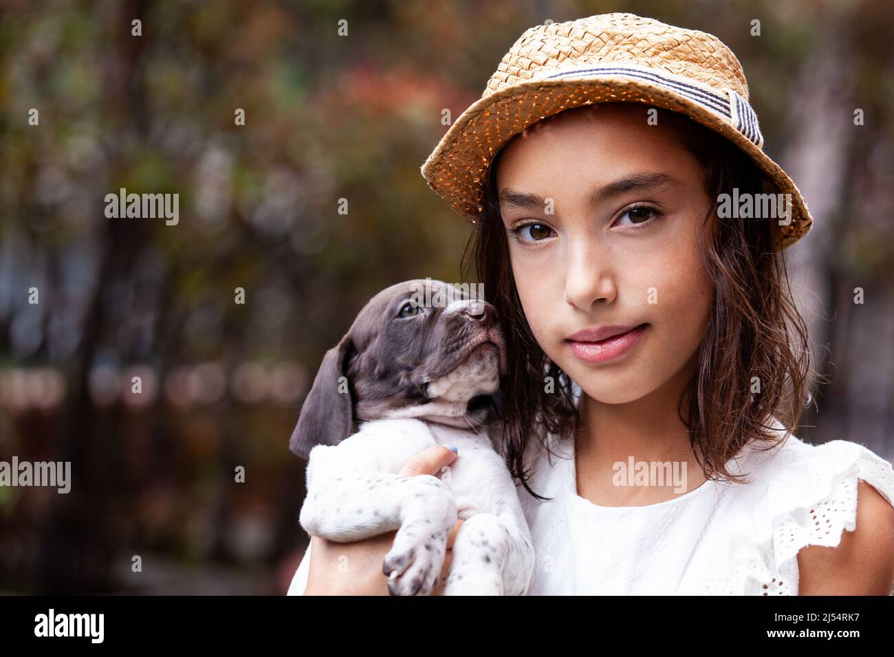 Beautiful young girl having fun with her small French Braque puppy ...