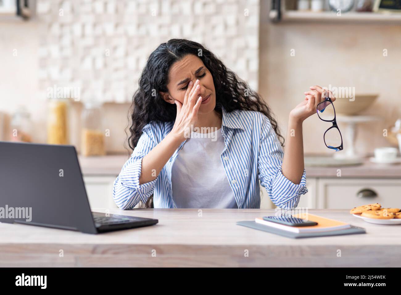 Eyes fatigue concept. Freelancer lady tired after working on laptop in ...