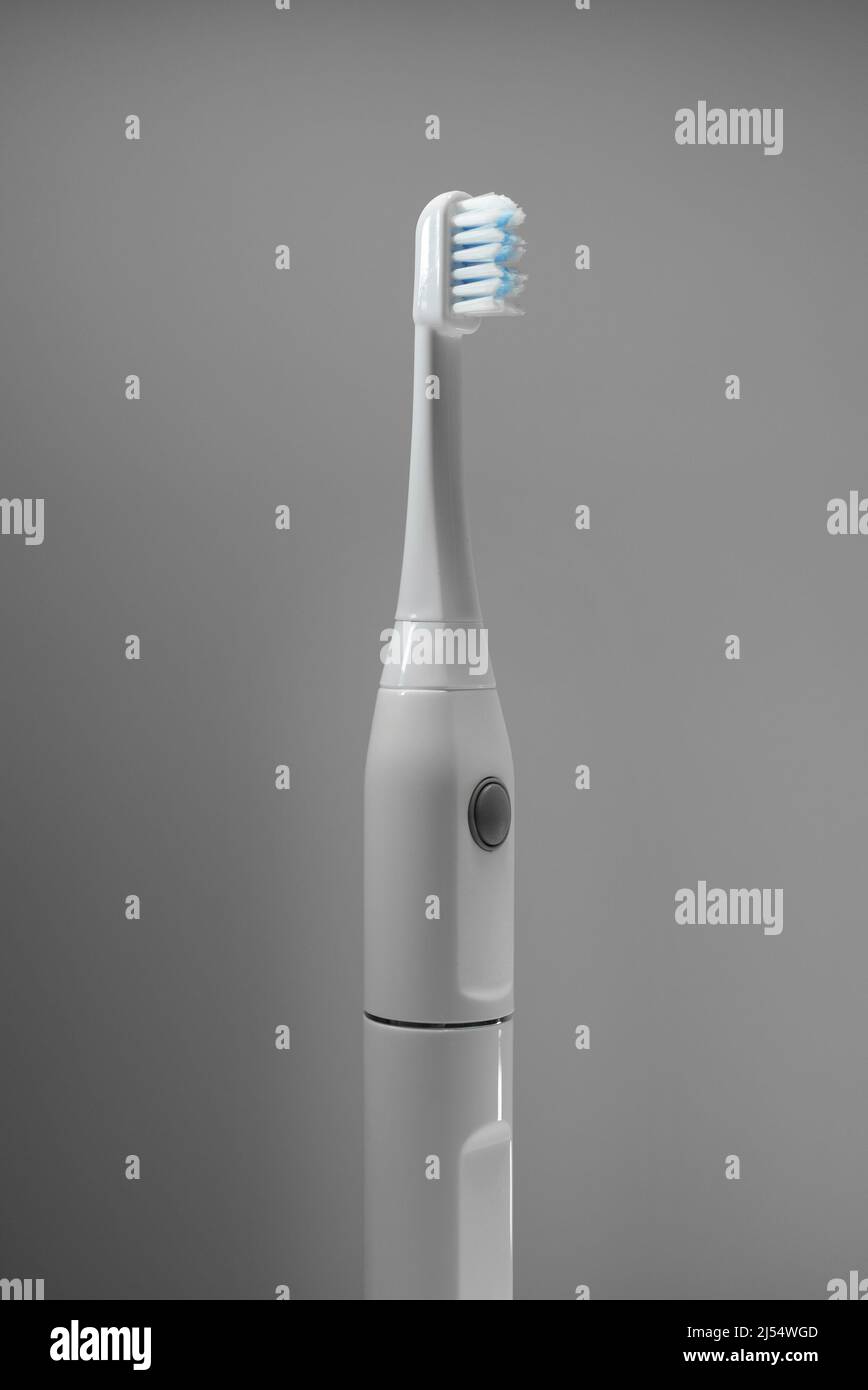 Electric ultrasonic toothbrush on grey background Stock Photo - Alamy