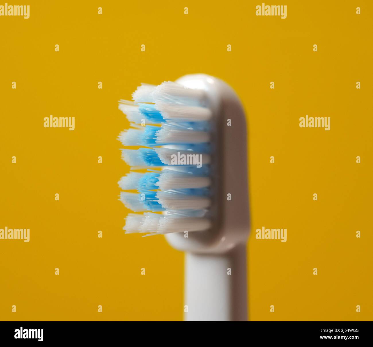Electric ultrasonic toothbrush bristles on yellow background Stock ...