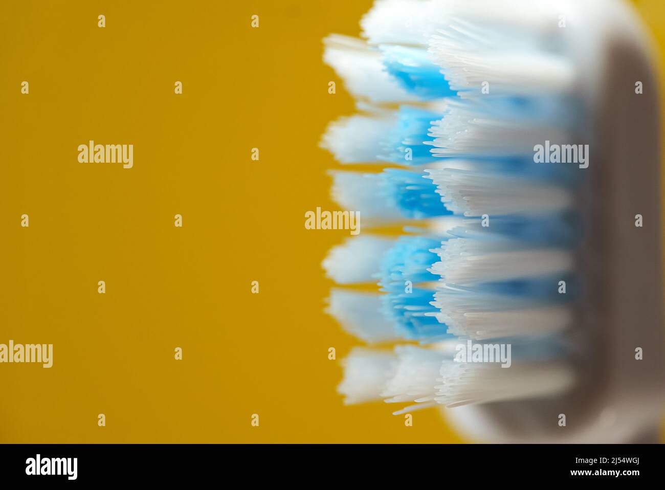 Electric ultrasonic toothbrush bristles on yellow background Stock ...