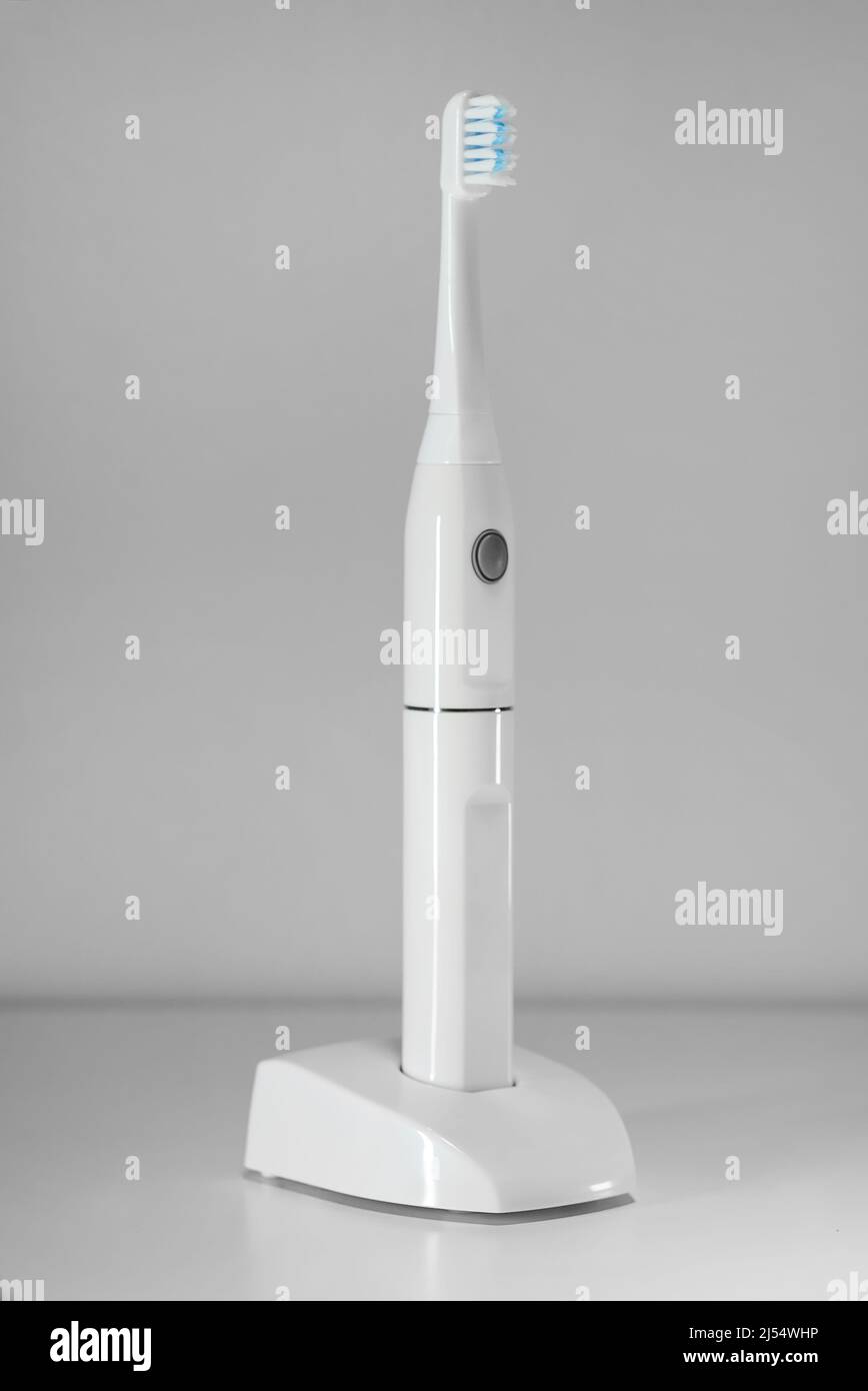 Electric ultrasonic toothbrush on grey background Stock Photo - Alamy