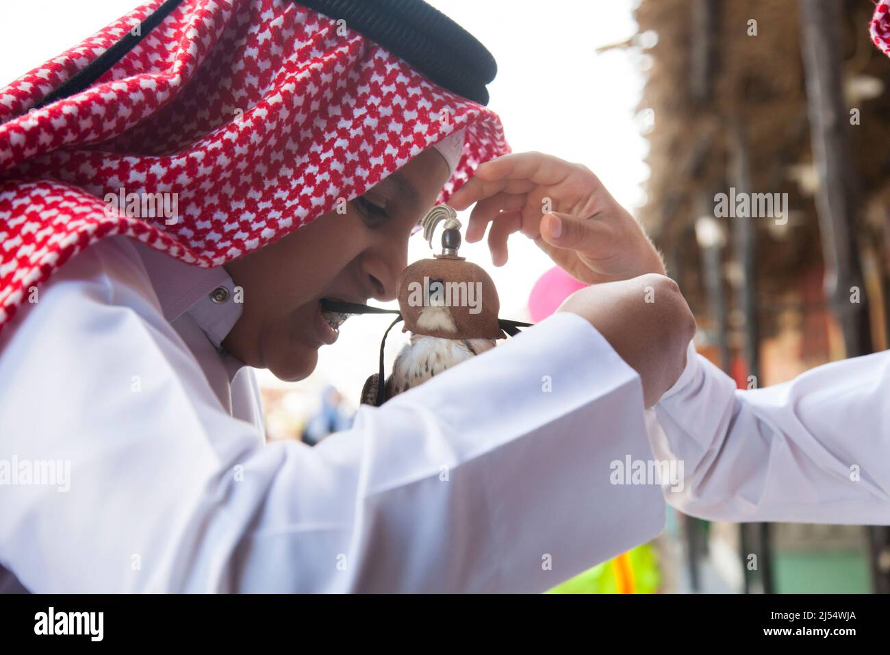 Doha ,Qatar-April 15,2022 : Qatari children with a falcon in the area ...