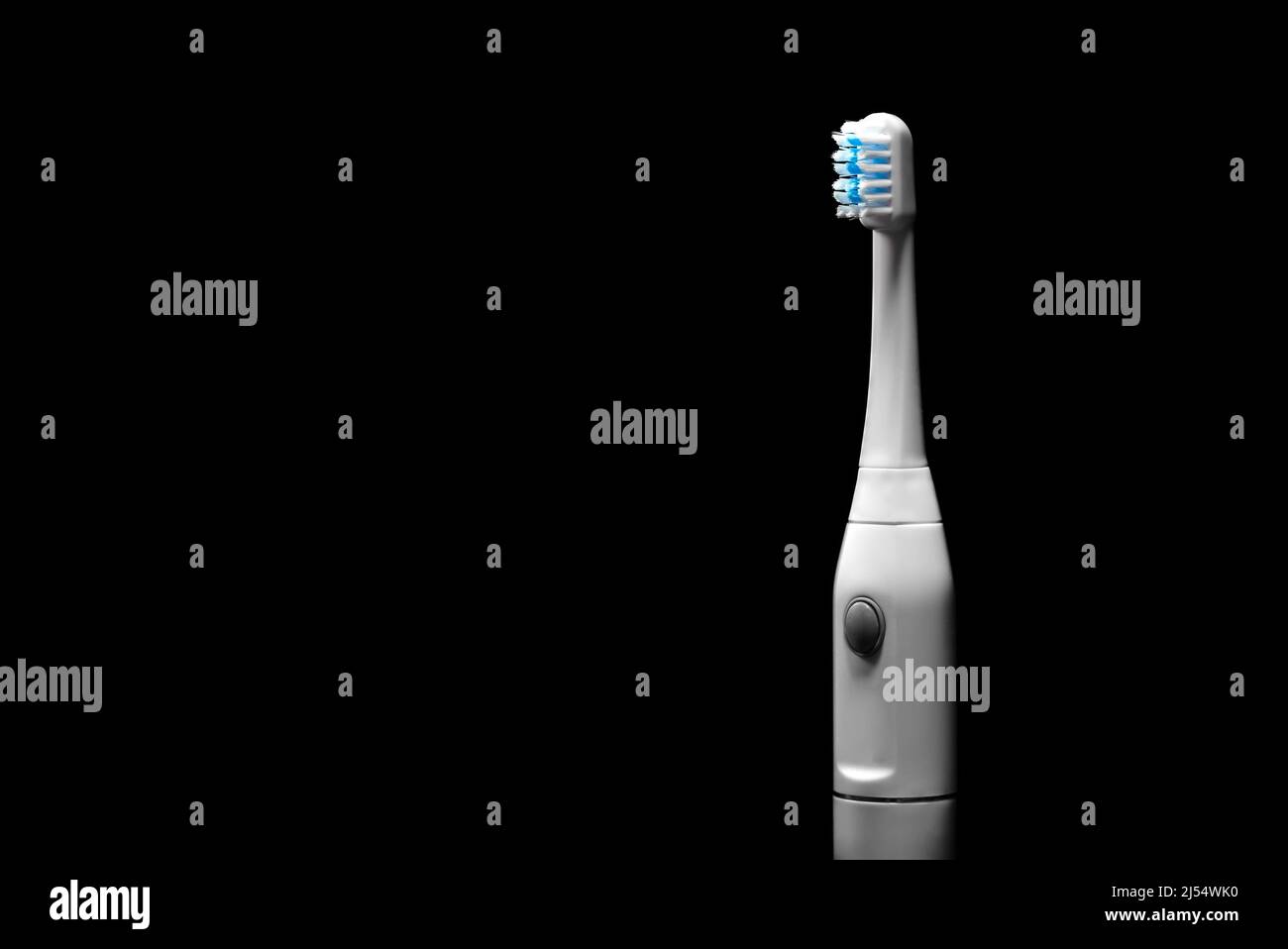 Electric ultrasonic toothbrush on black background Stock Photo - Alamy