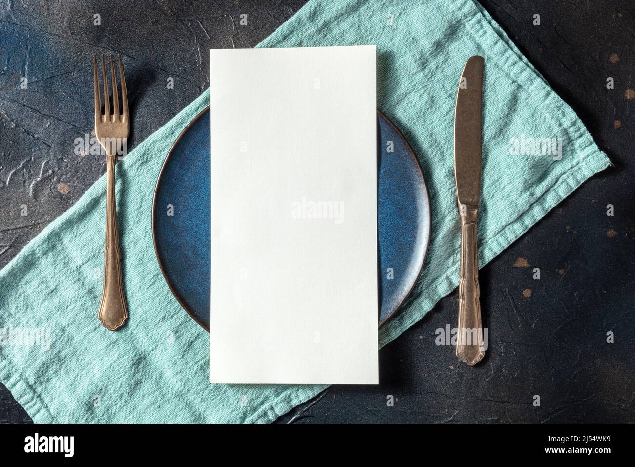 Dinner menu or invitation concept. A piece of white paper on a set ...