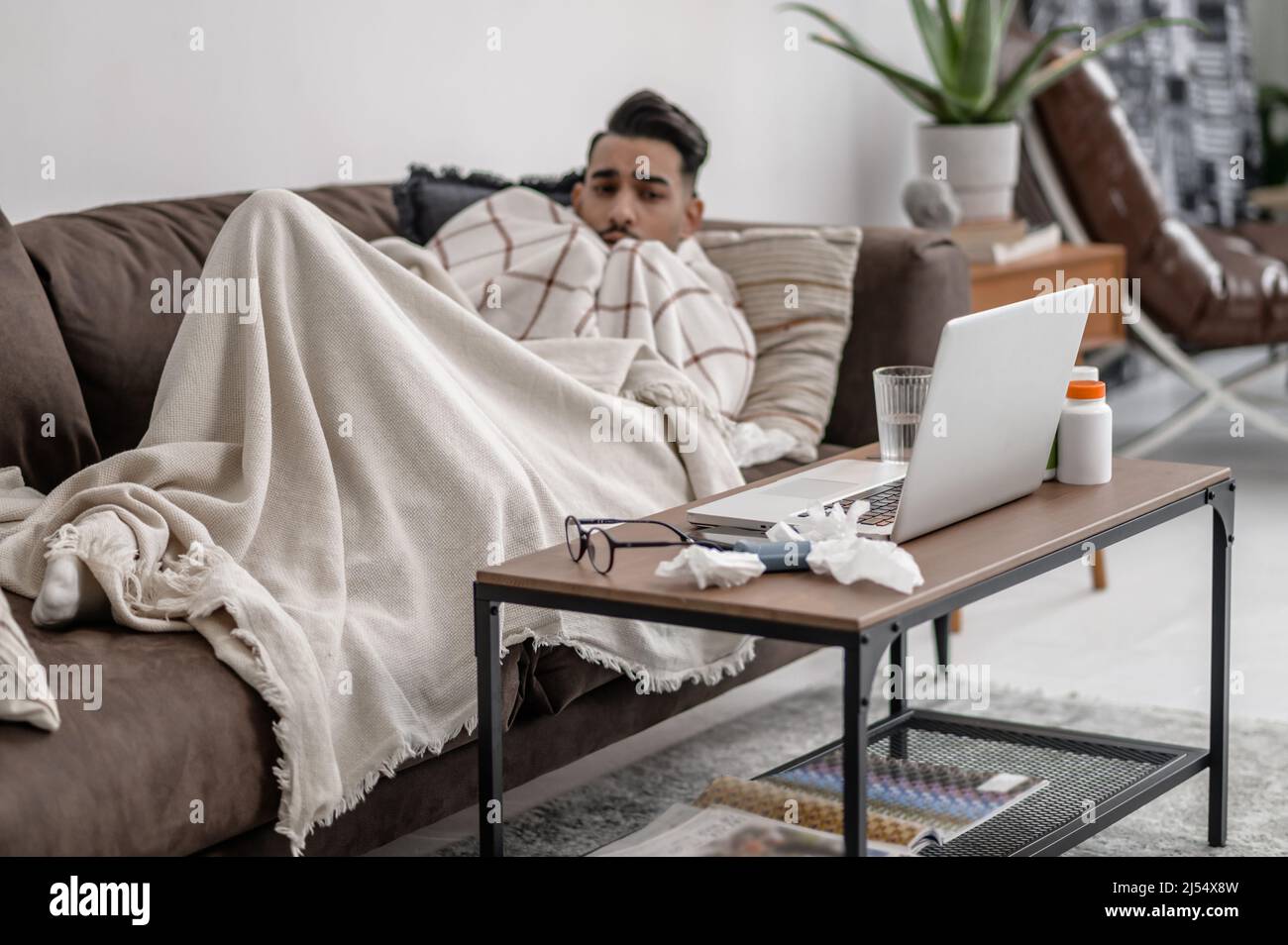 A sick man feeling bad and lying in bed Stock Photo - Alamy