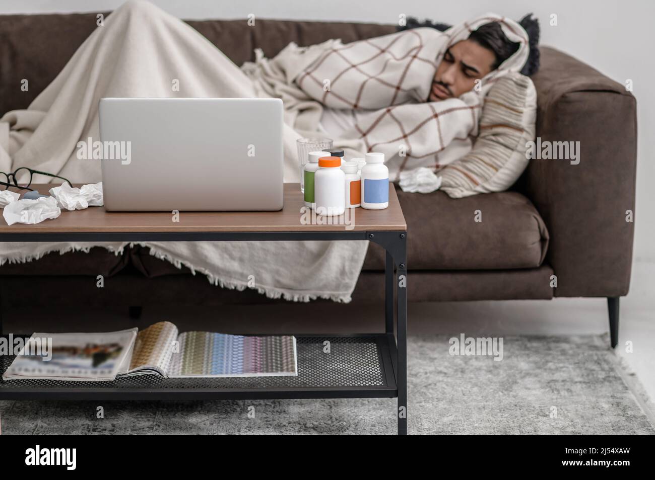 A sick man feeling bad and lying in bed Stock Photo - Alamy