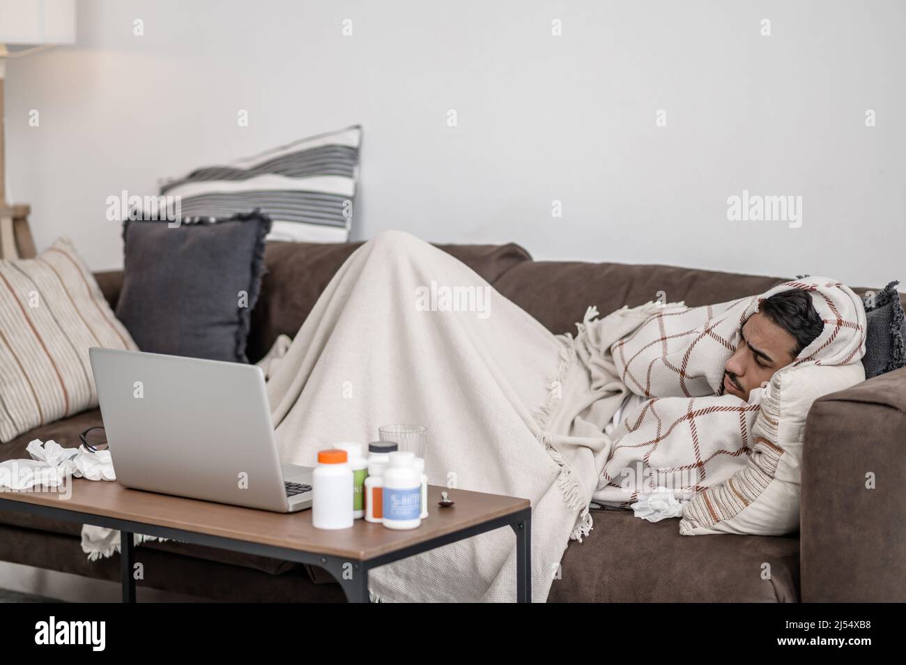 A sick man feeling bad and lying in bed Stock Photo - Alamy