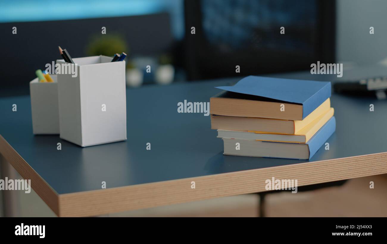 Close up of desk with school books for education and studying at home ...