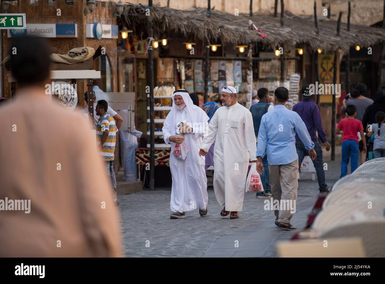 Doha,Qatar - April 15,2022 : Qatari locals in traditional attire hang ...