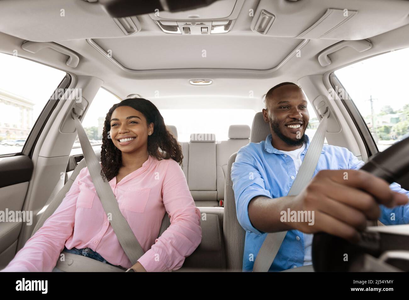 Happy black couple enjoying drive on new car Stock Photo - Alamy