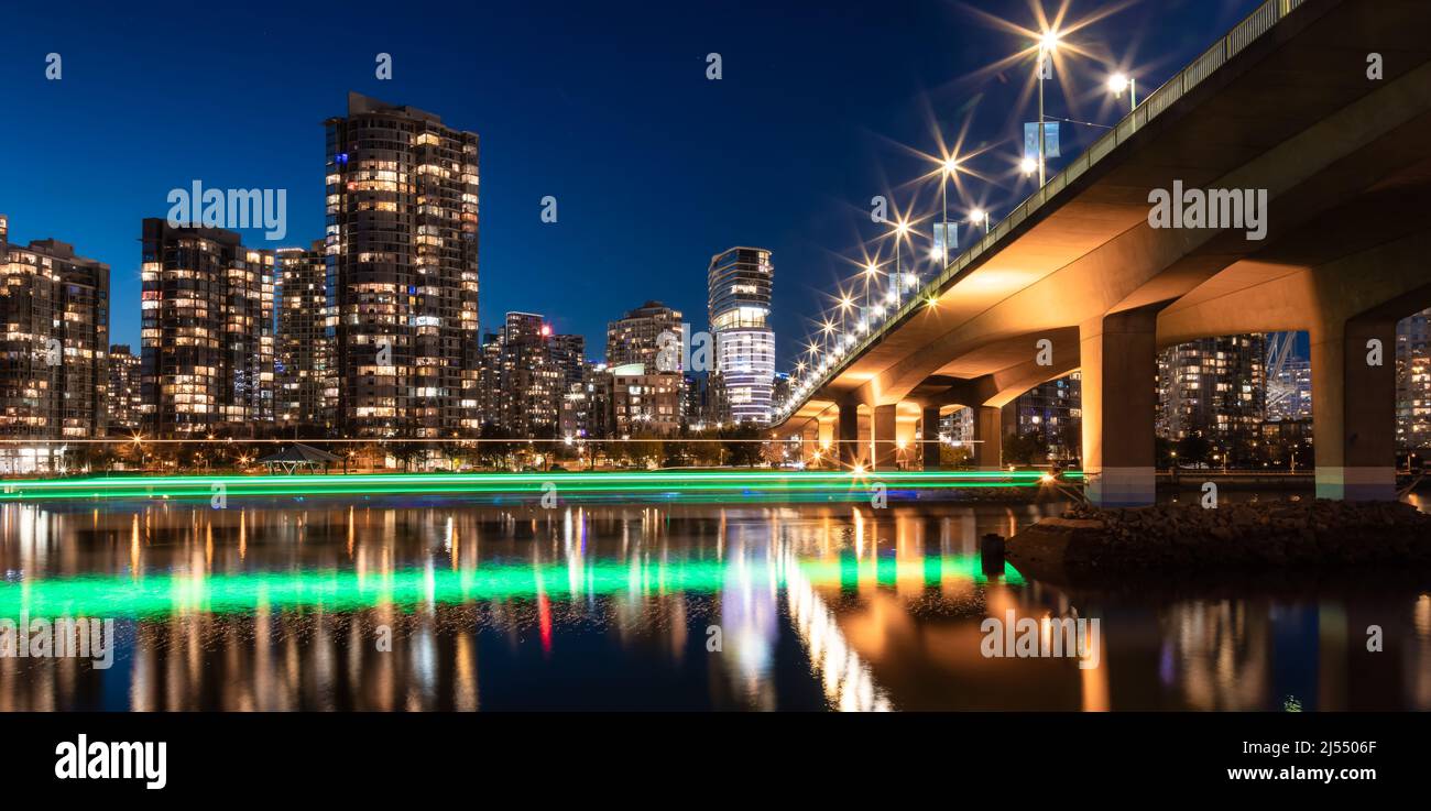 Cambie Bridge in False Creek with modern city buildings at night after ...