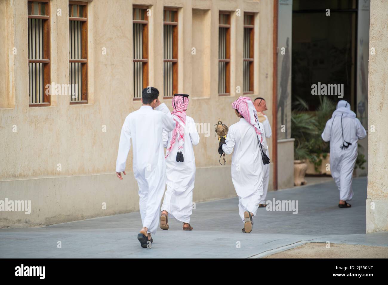 Doha,Qatar - April 15,2022 : Qatari locals in traditional attire hang ...