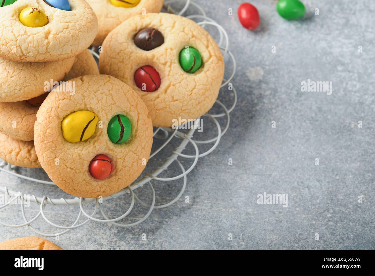 Homemade cookies with colorful chocolate candies and milk. Stack of ...
