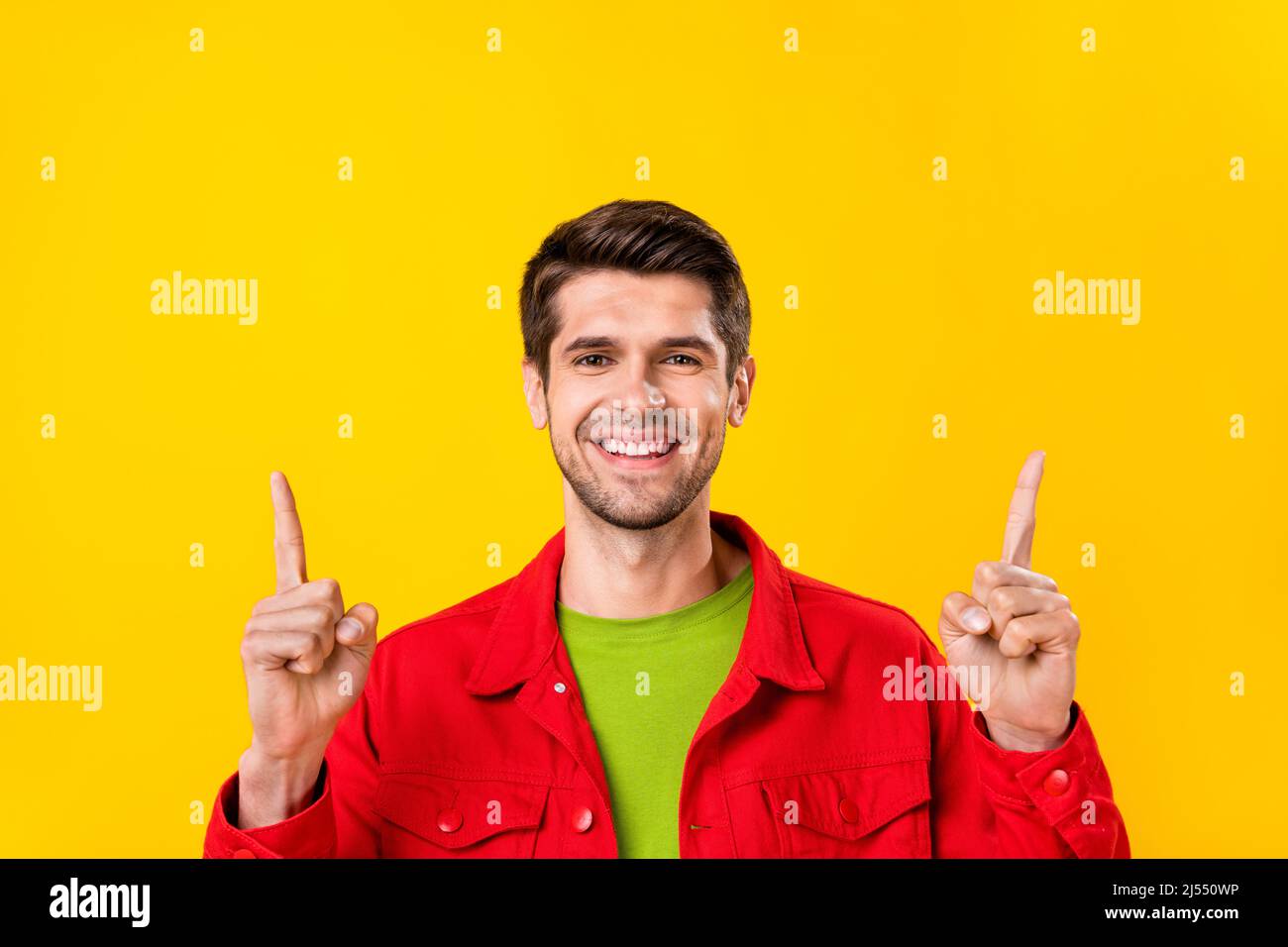 Portrait of attractive cheerful confident guy demonstrating up copy ...