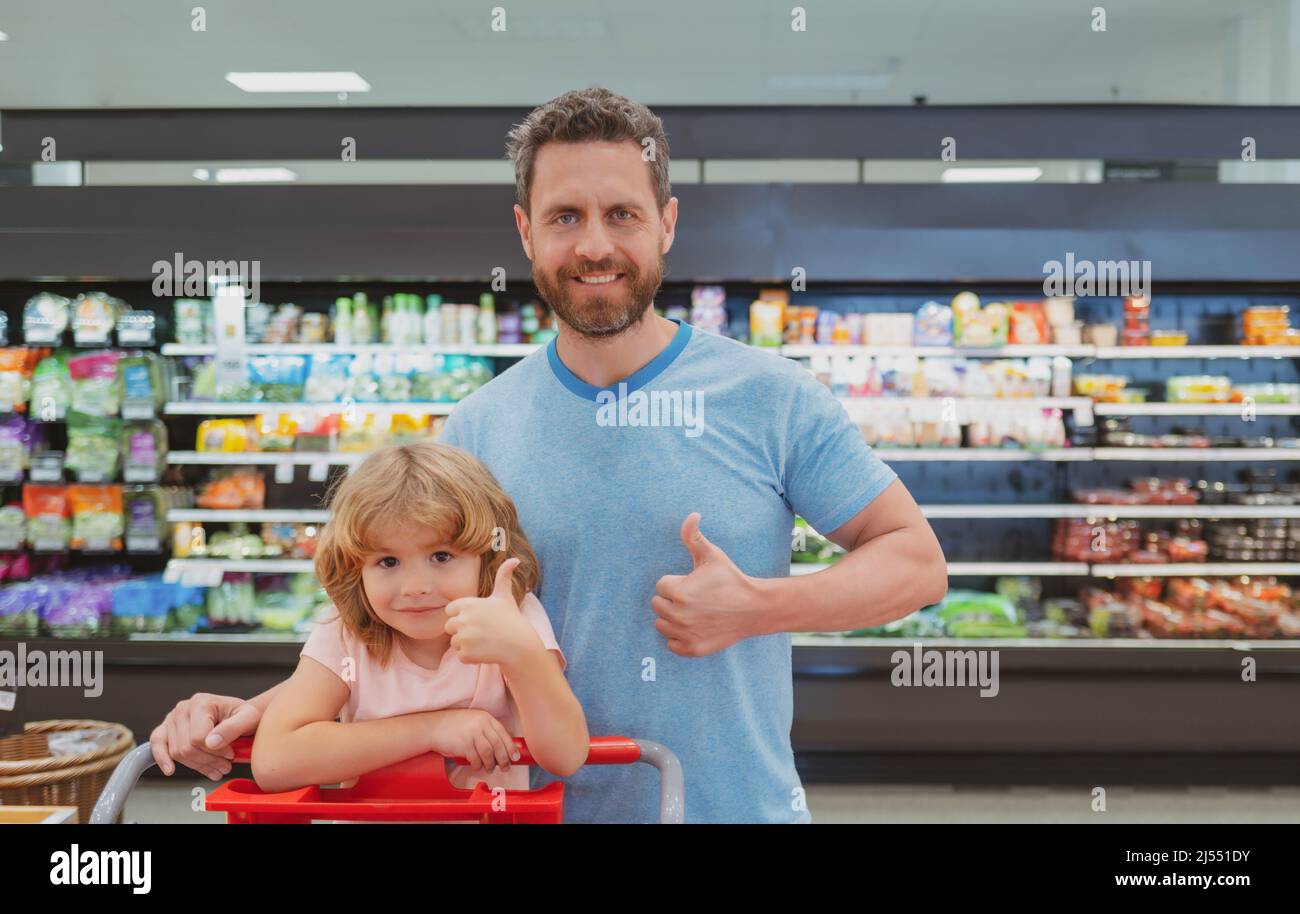 Father and son buy fresh vegetable in grocery store with thumbs up ...
