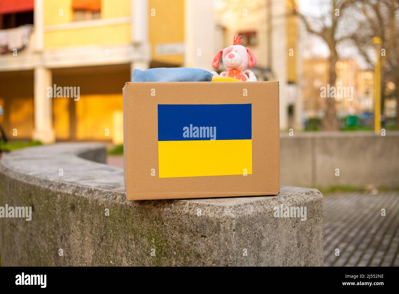 A box with a Ukrainian flag for donating humanitarian aid with things ...