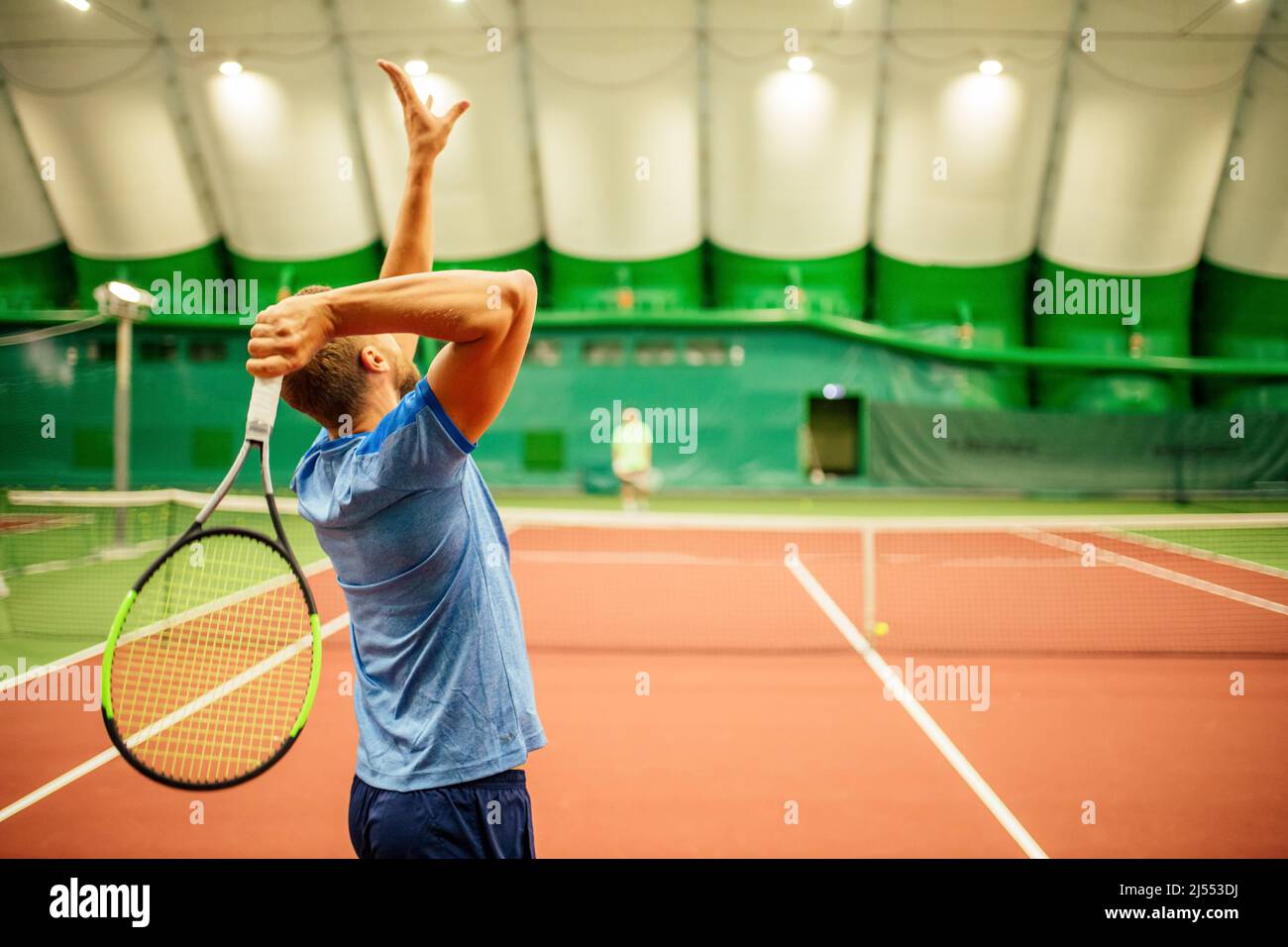 Instructor or coach teaching how to play tennis on a court indoor Stock ...