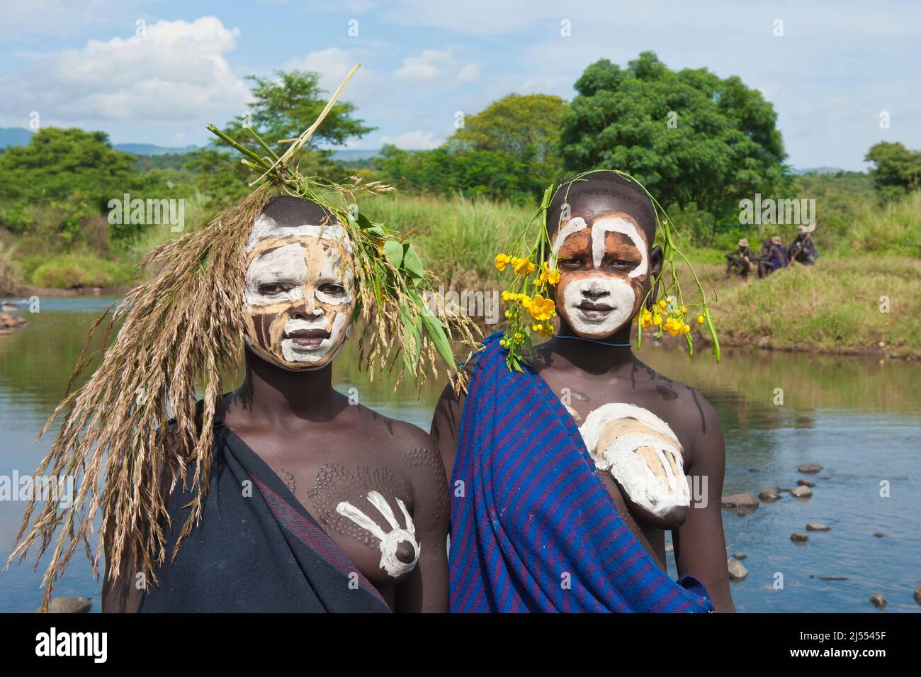 Young Surma women with body paintings in front of the river, Kibish ...
