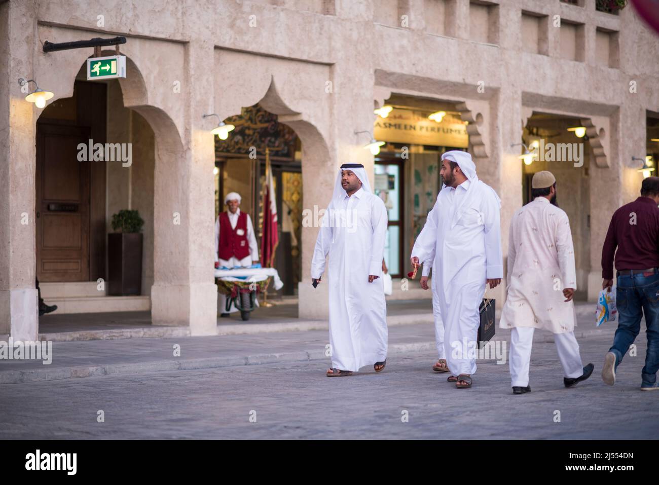 Doha,Qatar - April 15,2022 : Qatari locals in traditional attire hang ...