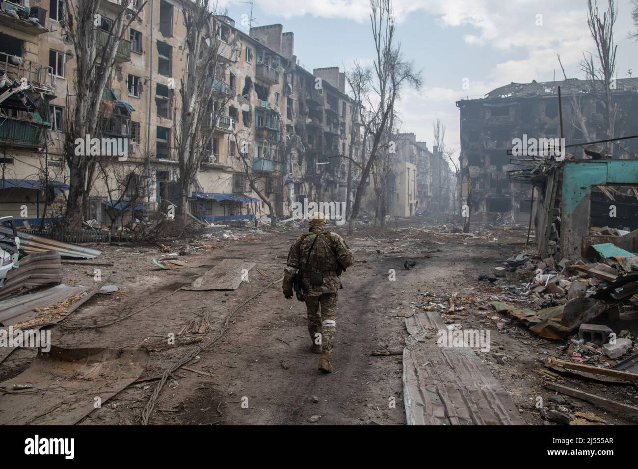 A Russian soldier walks amidst the rubble in Mariupol's eastern side ...