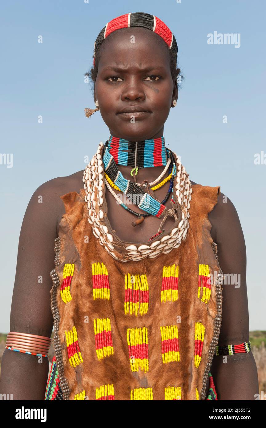 Young Hamar woman wearing necklaces made of Cowry shells and plastic ...