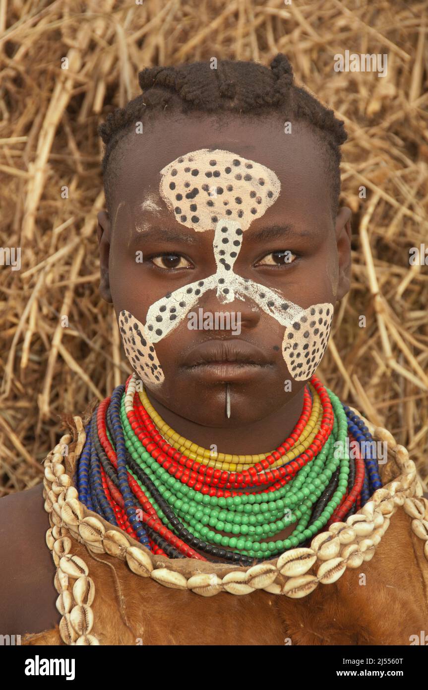 Portrait of a young Karo woman with lots of colorful necklaces and ...