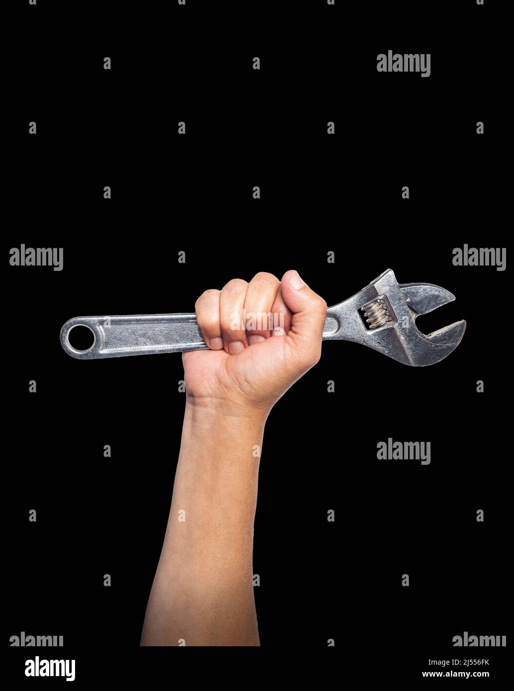 Arm of a man showing muscle gripping a pipe wrench on a black ...
