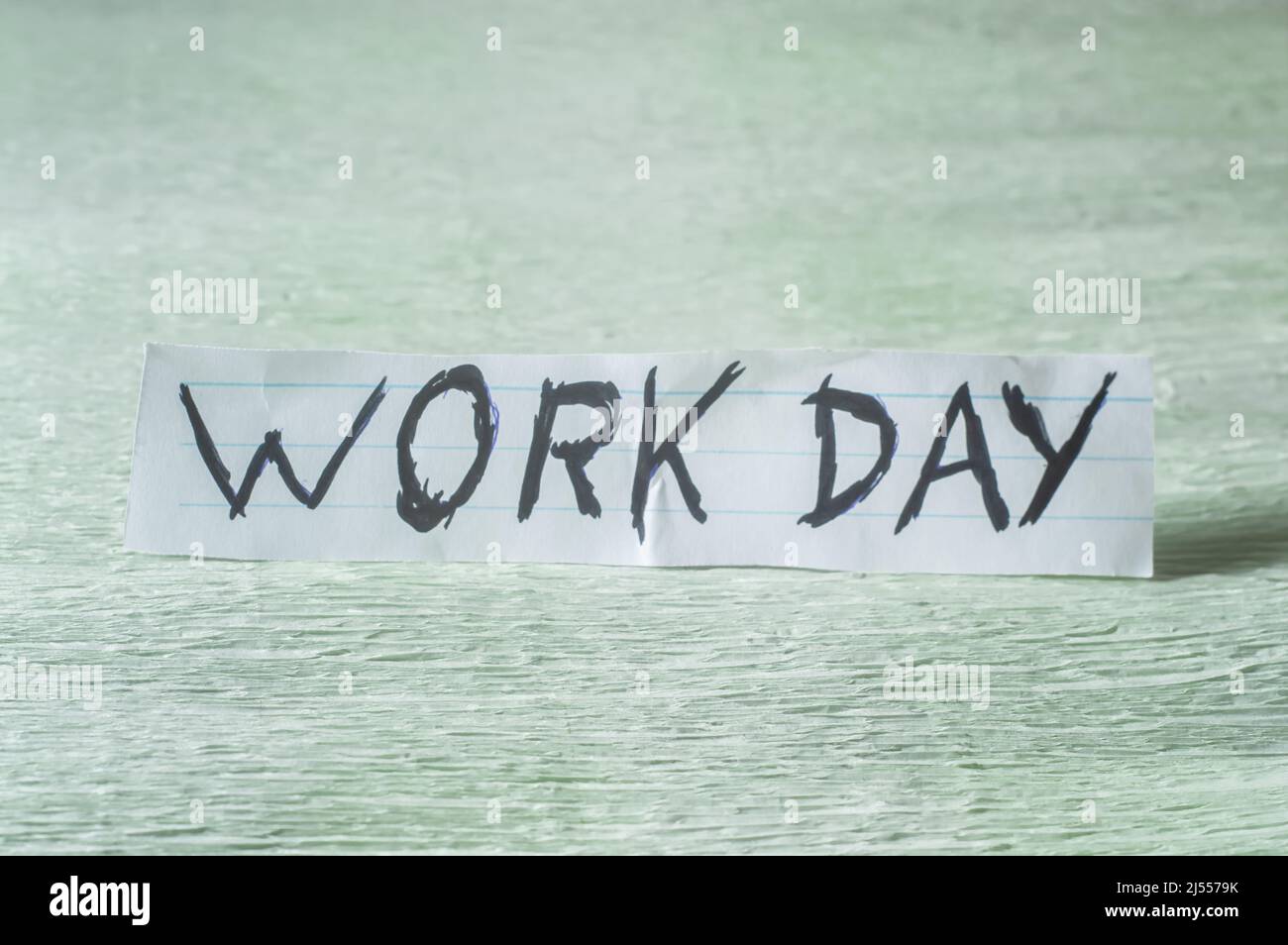 Work day,words written on a paper that is in a light green place Stock ...