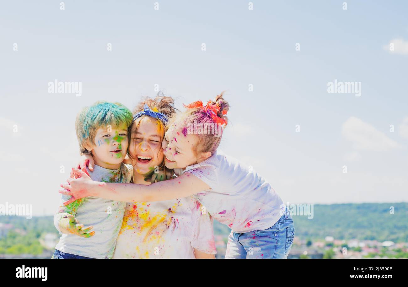 Happy childhood. Portrait of kids in colored powder holi. Kids face ...