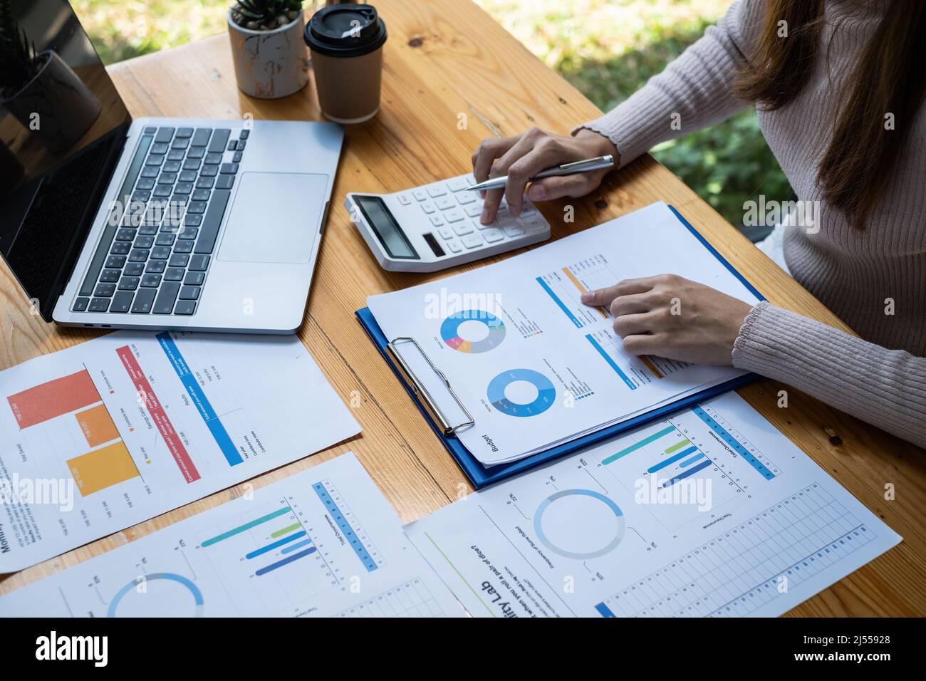 Close up Business woman hand using calculator application on laptop to ...