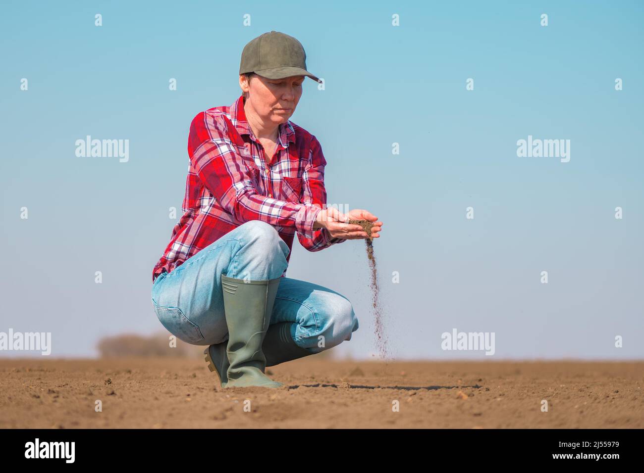 Farmer checking soil quality in plowed field before sowing season Stock ...