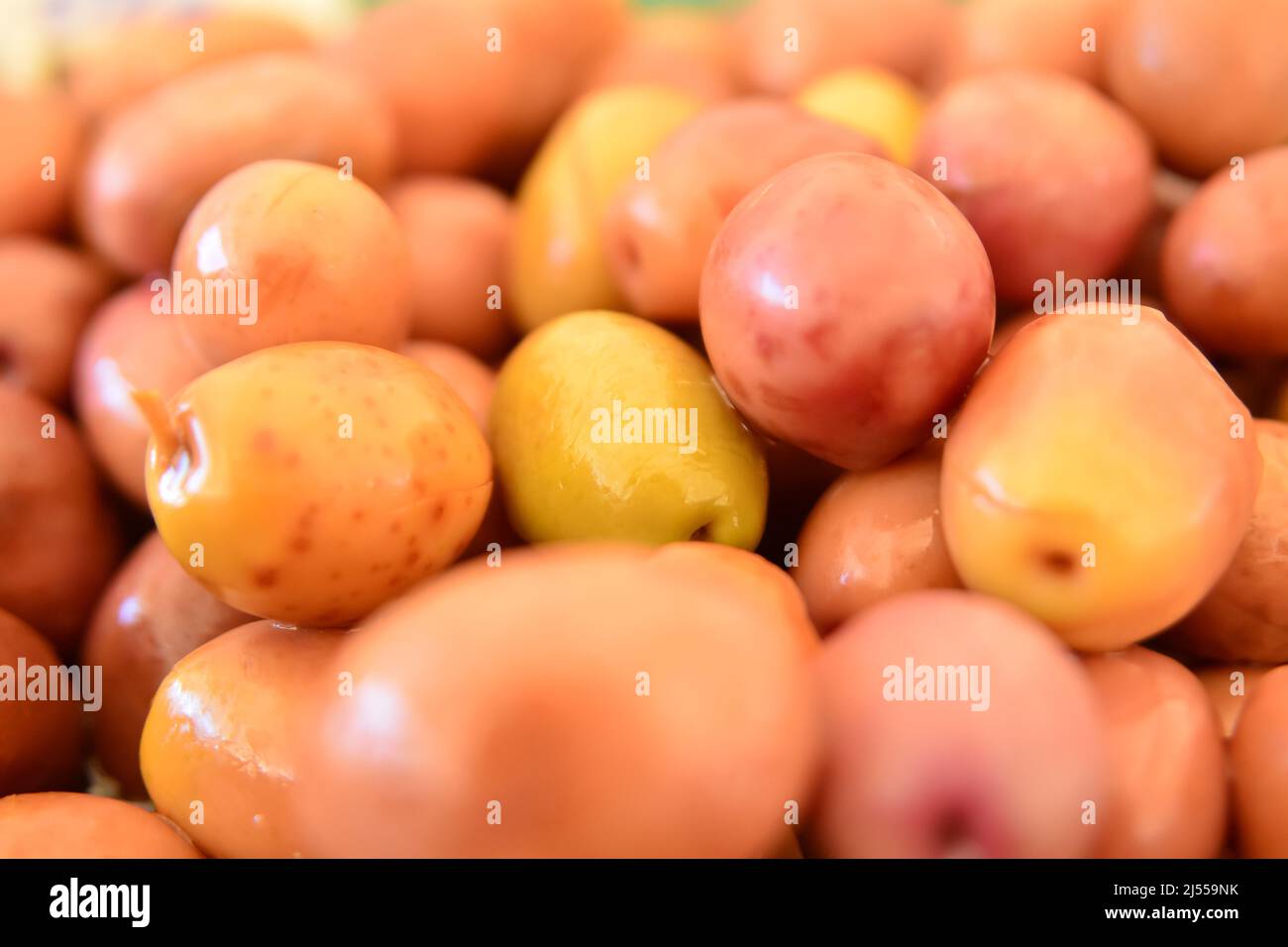 Very freshly pickled pink olives Stock Photo - Alamy
