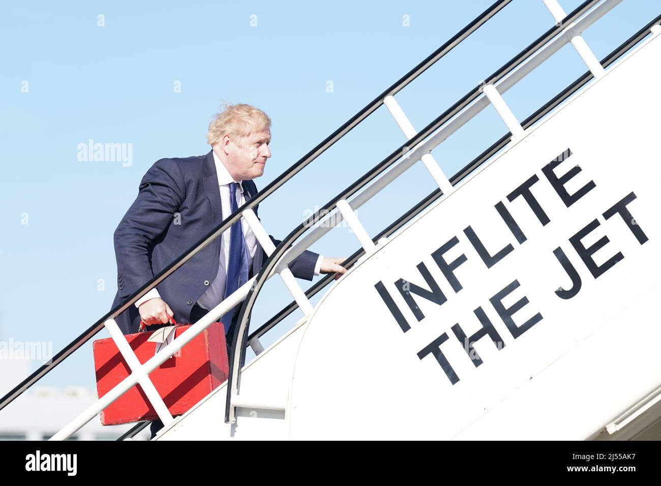 Prime Minister Boris Johnson boards a plane at Stansted Airport as he ...