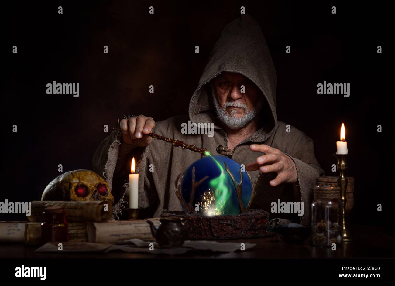 Medieval wizard cast magic with magic wand and crystal ball Stock Photo ...