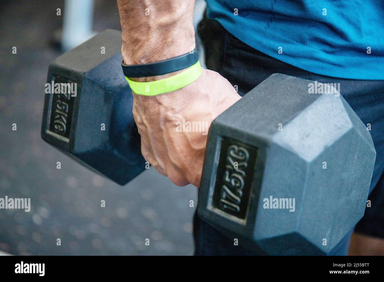 Stock photo of a detail of a man's hand holding a weight. Fitness and ...