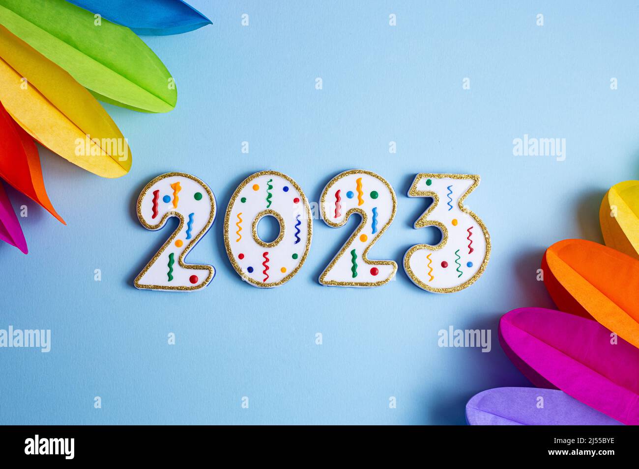 Multicolored numbers 2023 on the blue background.Bright paper decor ...