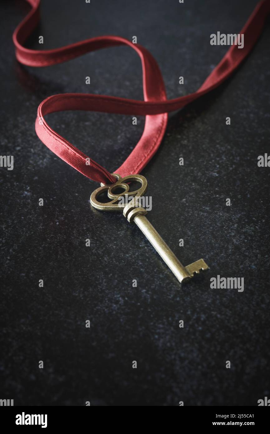Key on red ribbon Stock Photo - Alamy