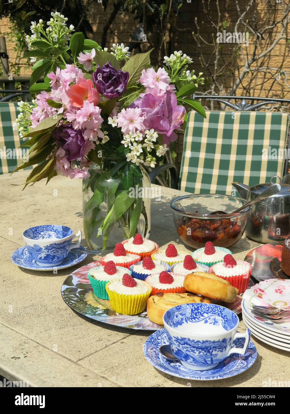 Outdoor living: a jar of spring flowers and an afternoon tea laid out ...