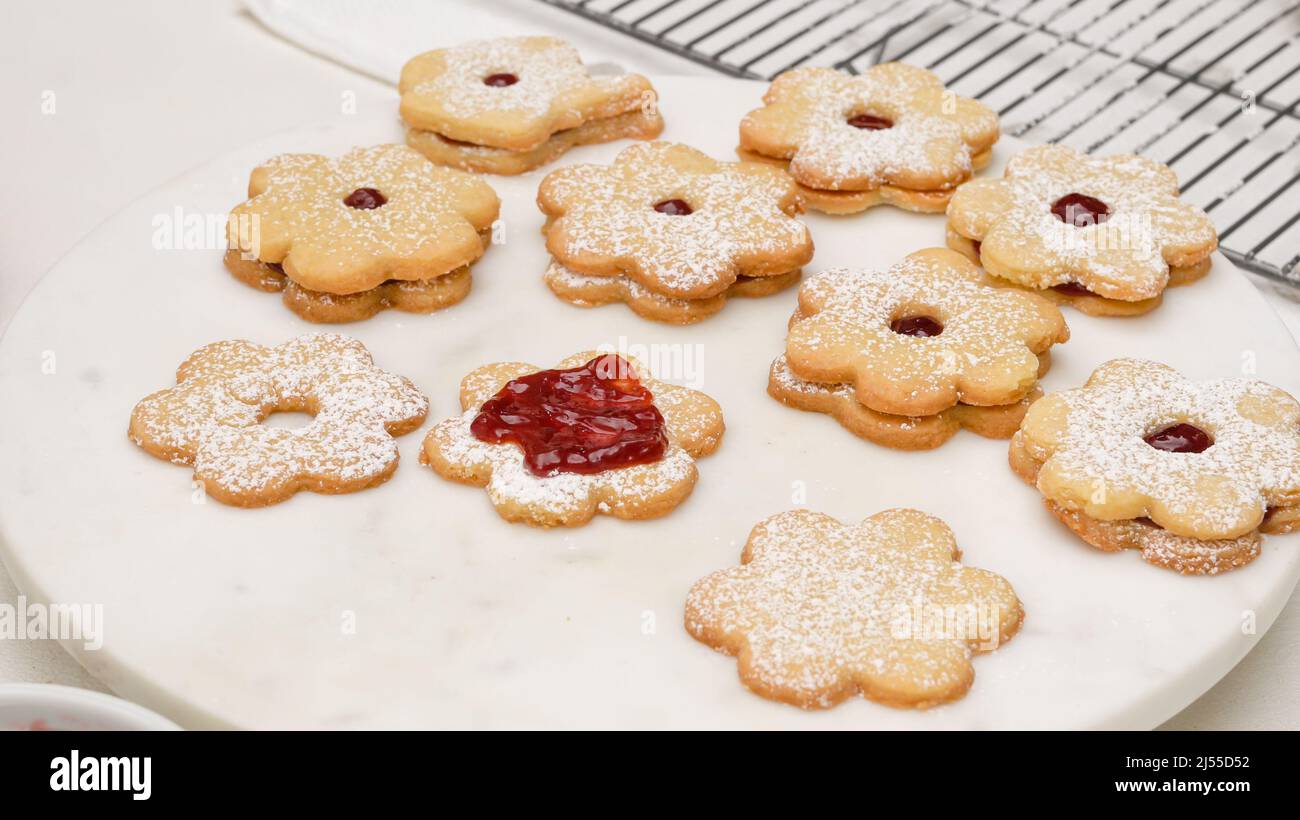 Flower-shaped shortbread cookies filled with raspberry jam step by step ...