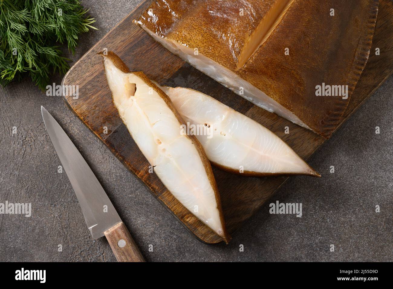 Smoked halibut slices cutted on brown background. View from above Stock ...