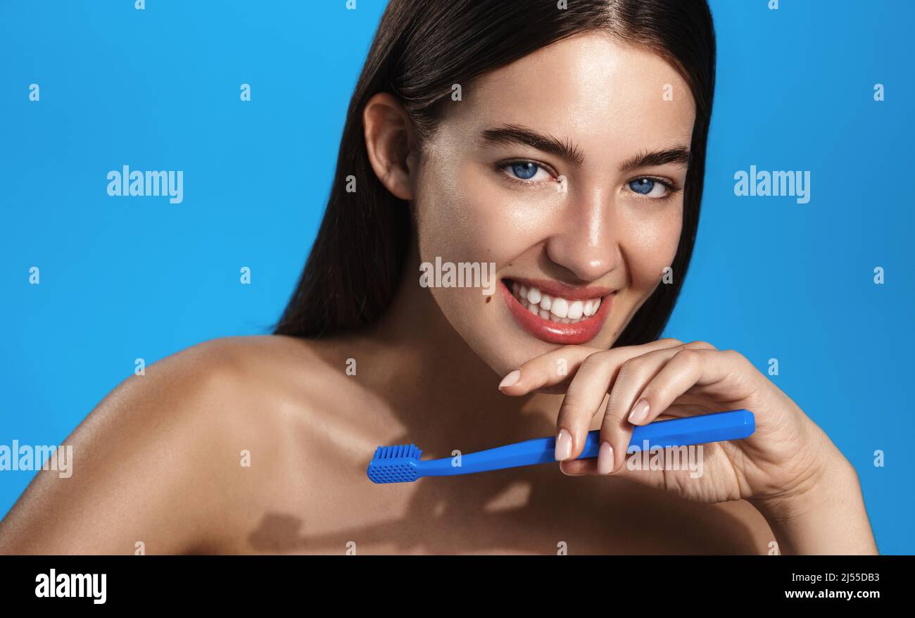 Girl with perfect white smile brushes teeth Stock Photo - Alamy