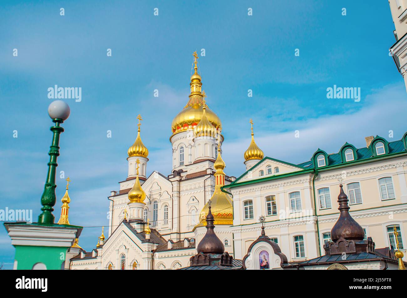 Orthodox Christian cathedral with golden domes. Religious buildings. Side view. Holy Dormition ...