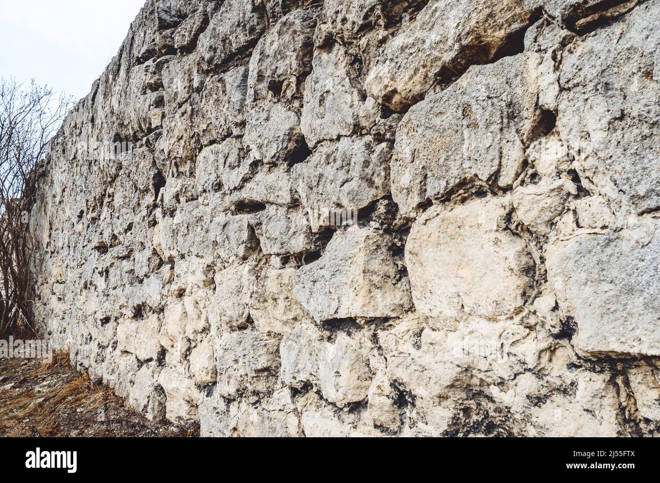 Stone wall. Paved wall with rough, clear texture and deep lines between ...