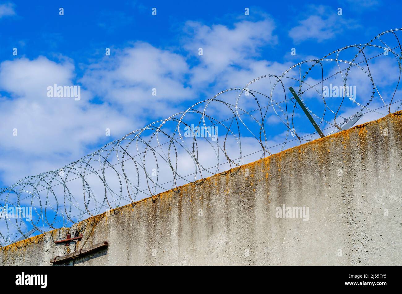 Barbed wire fence on high wall. Protection of important object Stock ...
