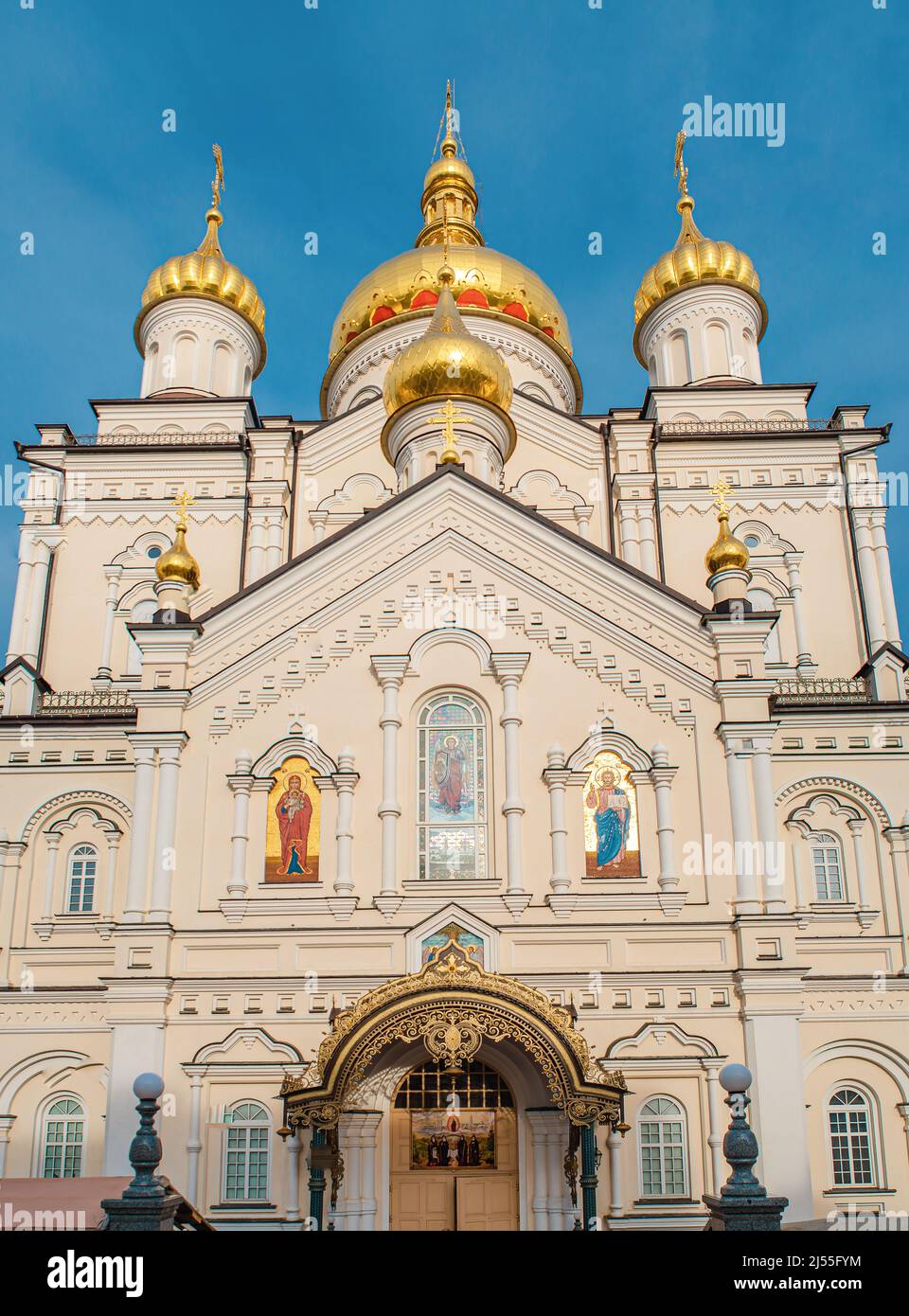 Majestic Christian Orthodox religious building. Arched windows, golden domes and crosses ...