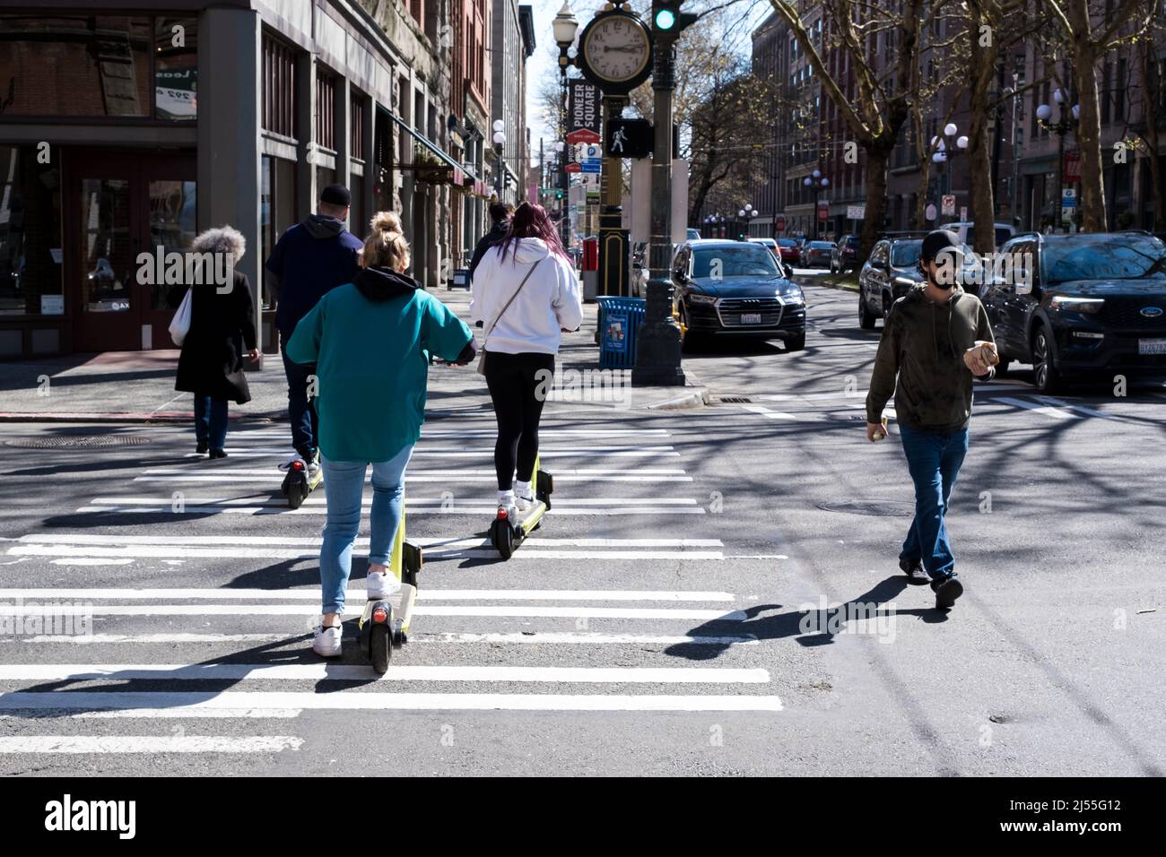 Seattle, USA. 15th Apr, 2022. Four people riding ev scooters in the ...