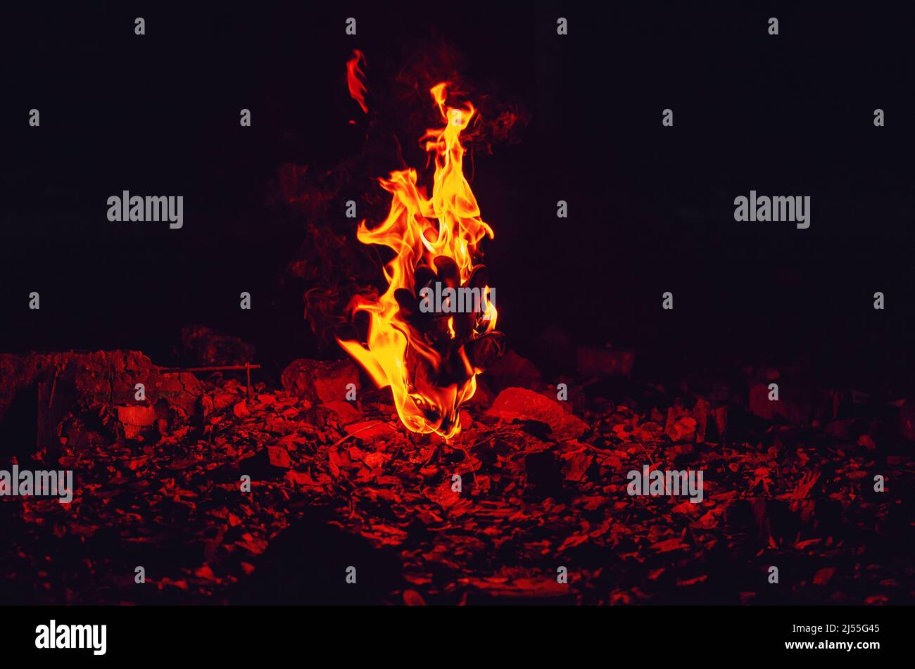 The glove is engulfed in flames. Bright fire in dark night Stock Photo ...