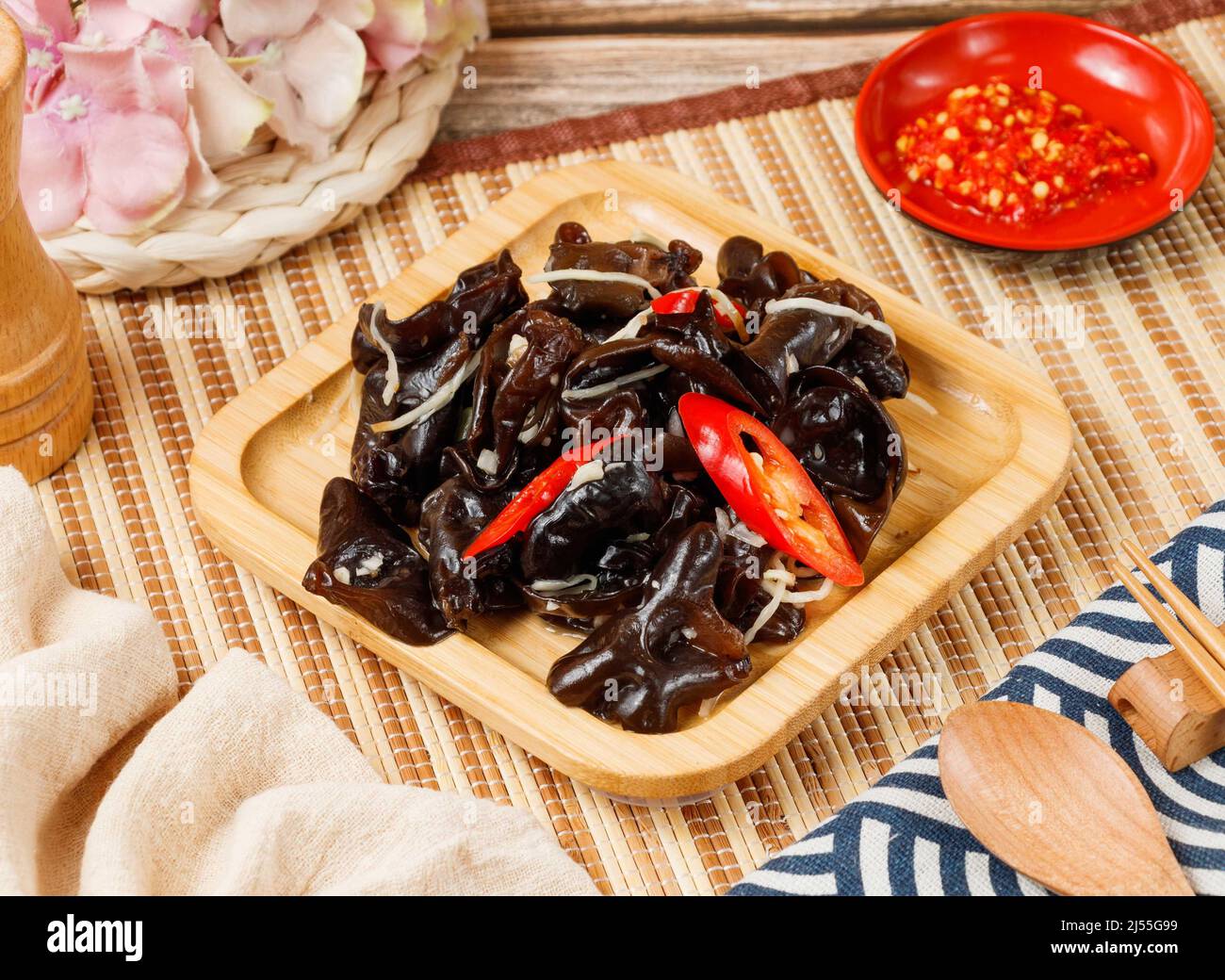 cold fungus in a bowl with spoon and chopsticks isolated on mat side ...