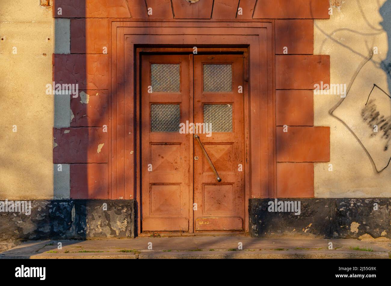 Wooden old big door in building. Brown door with glass. Ancient ...
